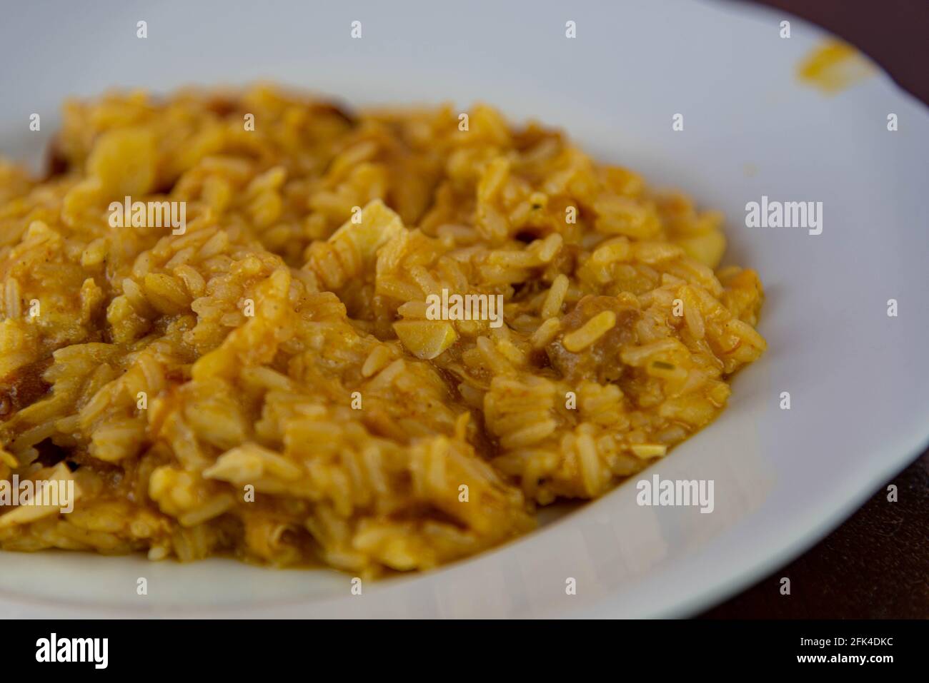 Homemade chicken risotto served on the white plate. Italian rice served ...