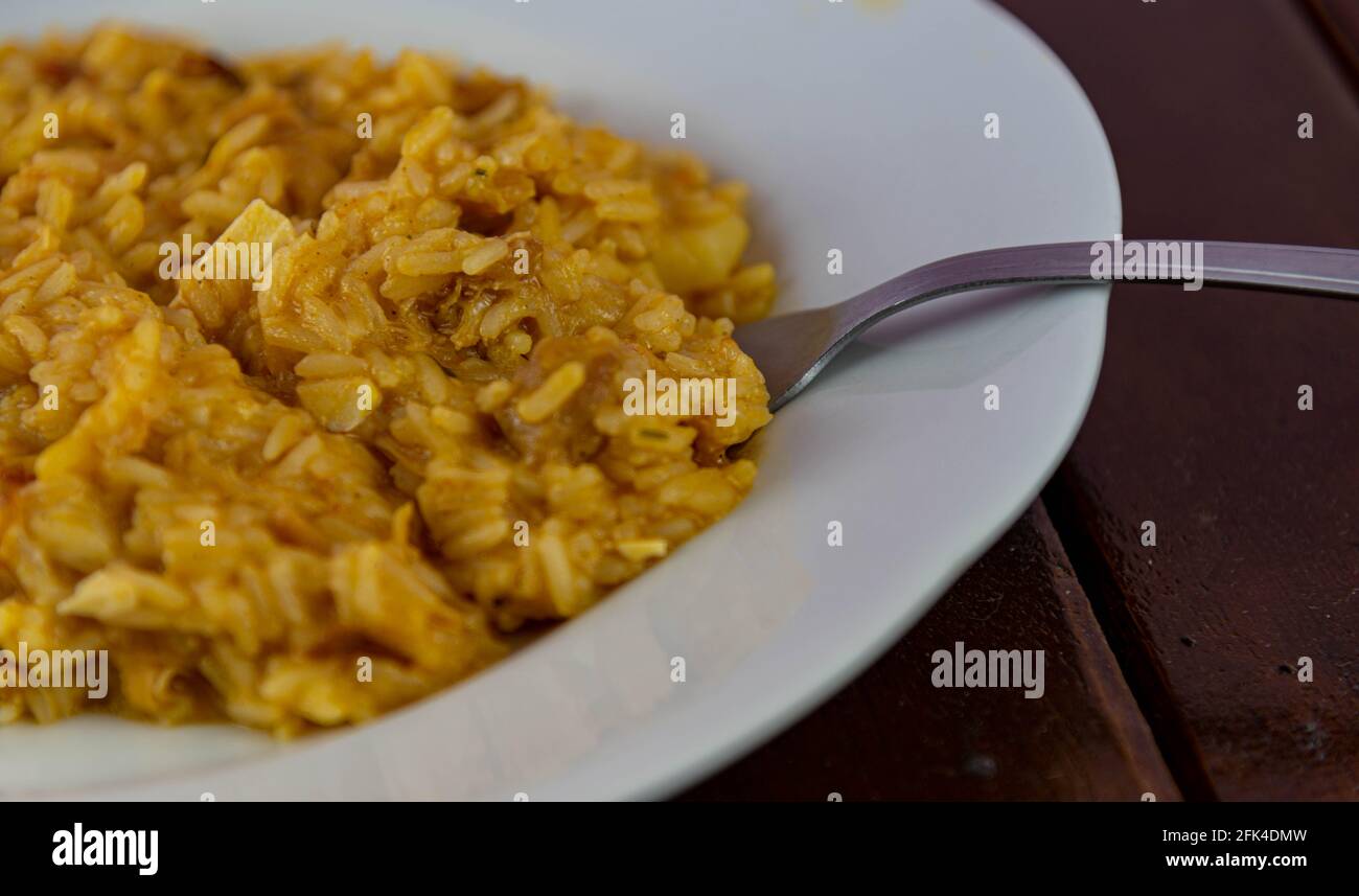 Homemade chicken risotto served on the white plate. Italian rice served ...