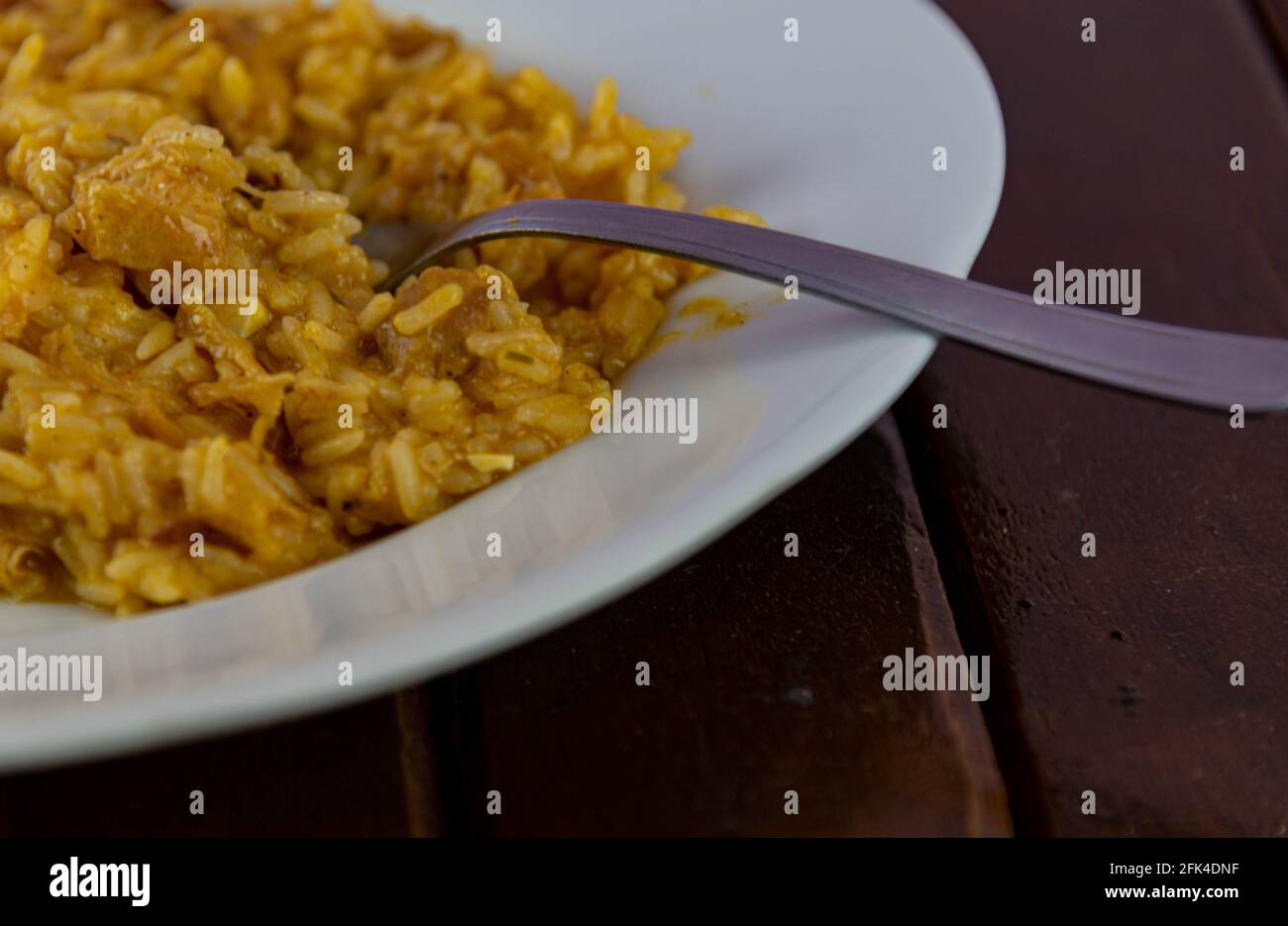 Homemade chicken risotto served on the white plate. Italian rice served ...