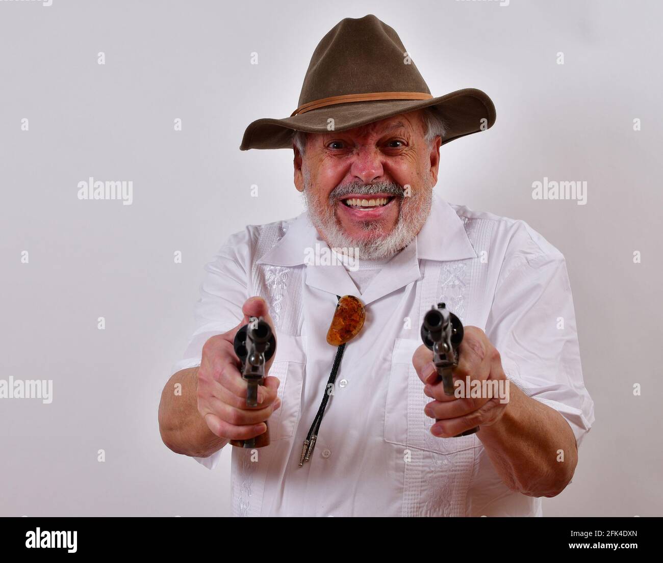 Angry senior man aiming two revolvers Stock Photo - Alamy