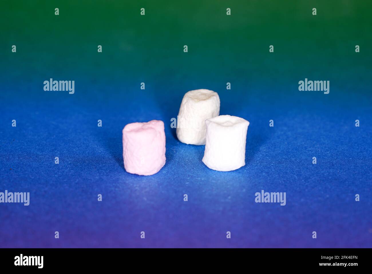 Closeup of three marshmallows on a colorful background Stock Photo - Alamy