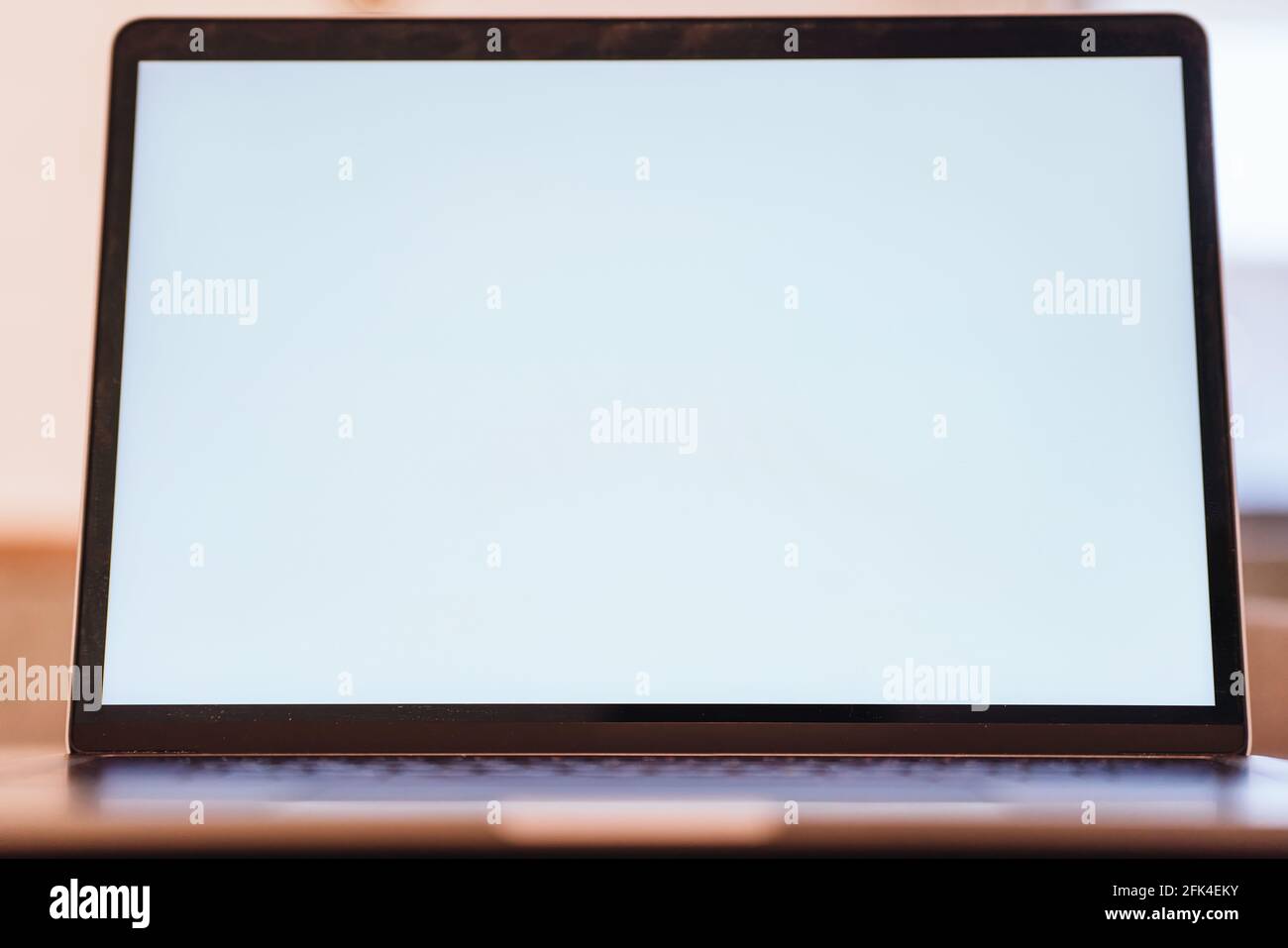 Conceptual workspace, Laptop computer with blank white screen on table ...