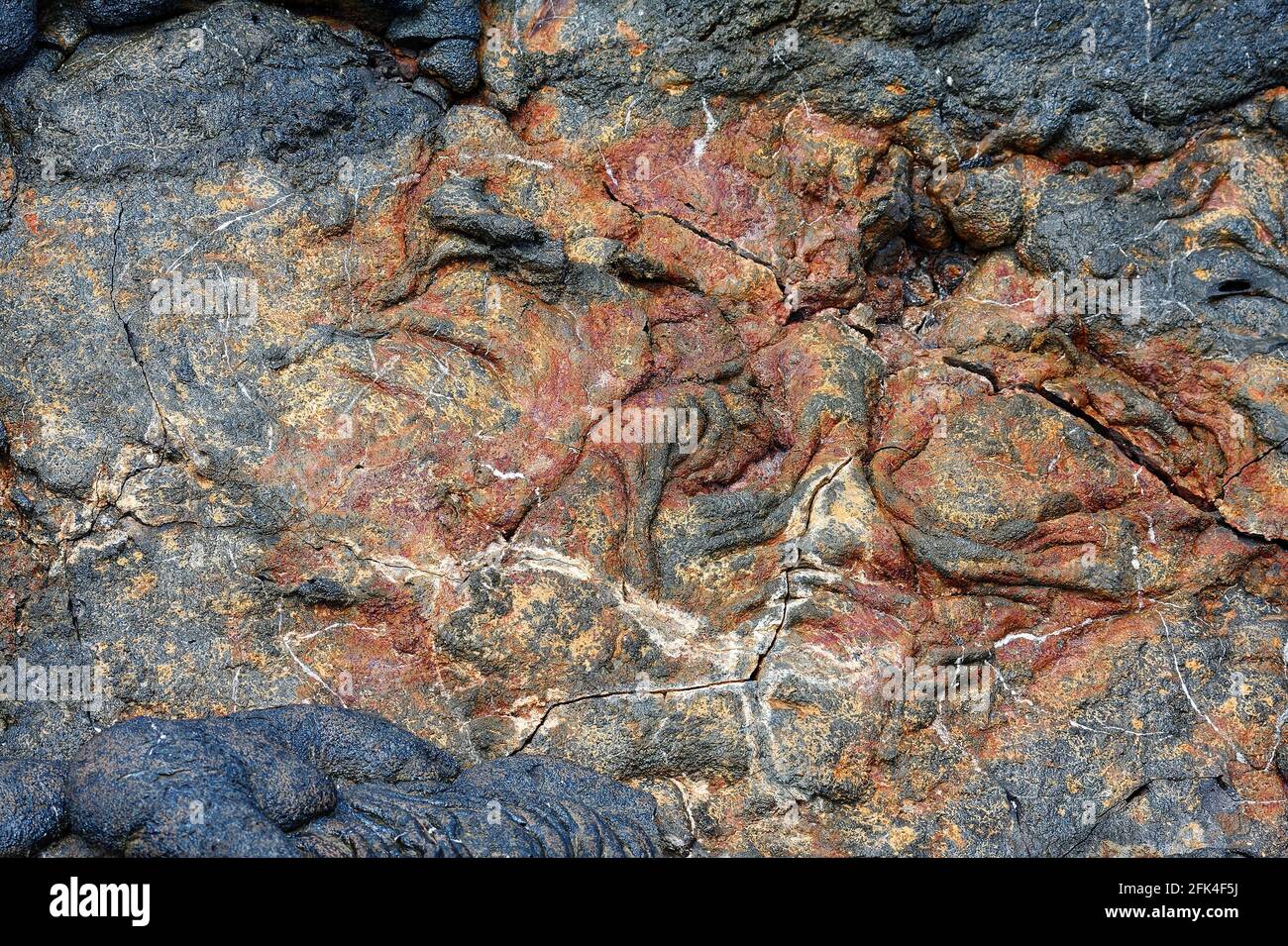 oxidation cracks in lava, grey shades, colored minerals, volcanic flow ...