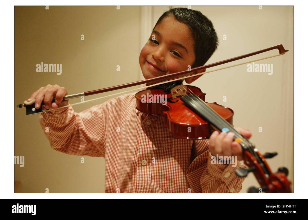 Kaisun Raj a 5 year old learning to play the Violin.....pic David ...