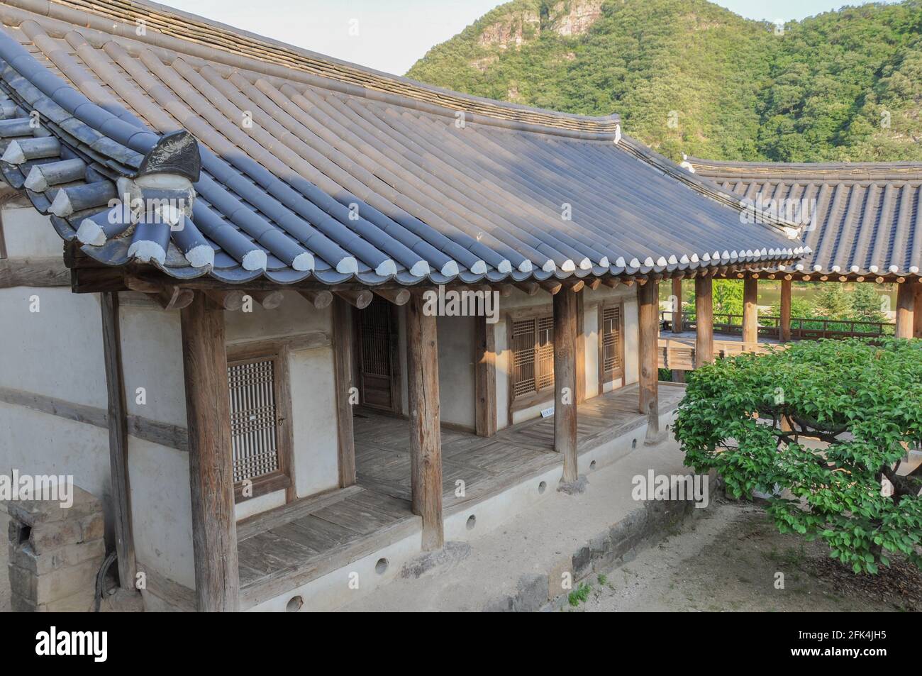 Courtyard with small tree and traditional korean buildings from it’s ...