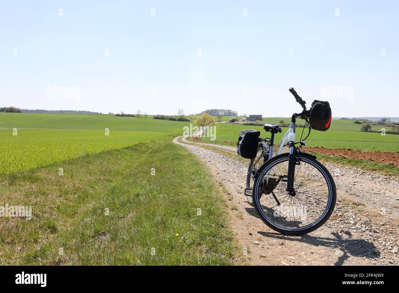 Spring landscape with an e-bike on the way Stock Photo - Alamy