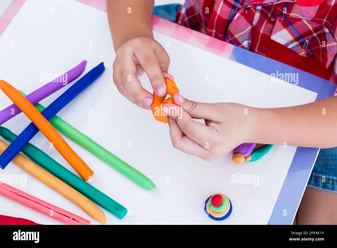 Close up child's hand creating toys from play dough. Strengthen the ...