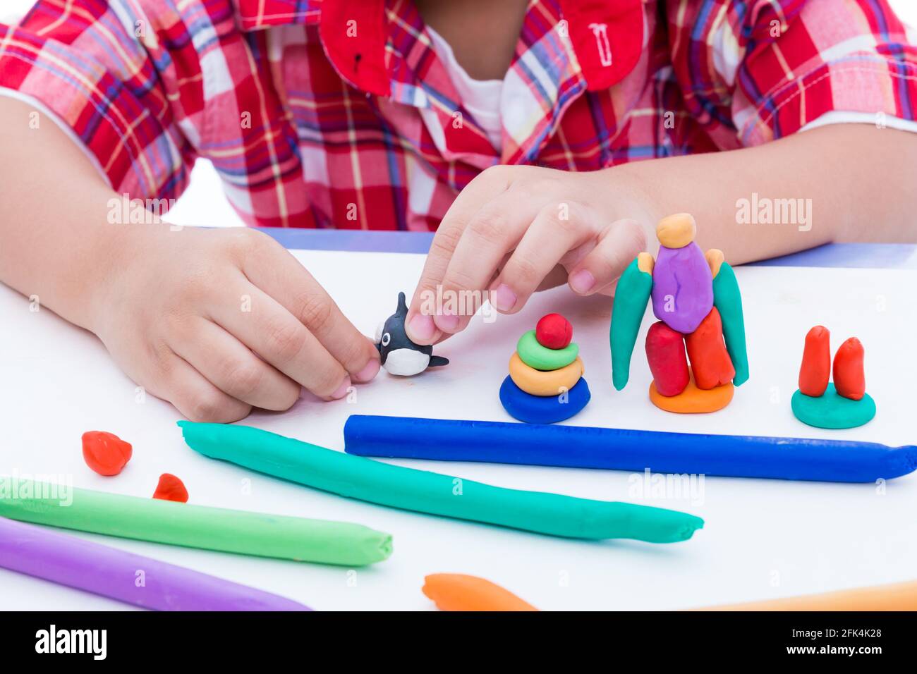 Close up child's hand creating toys from play dough. Strengthen the ...