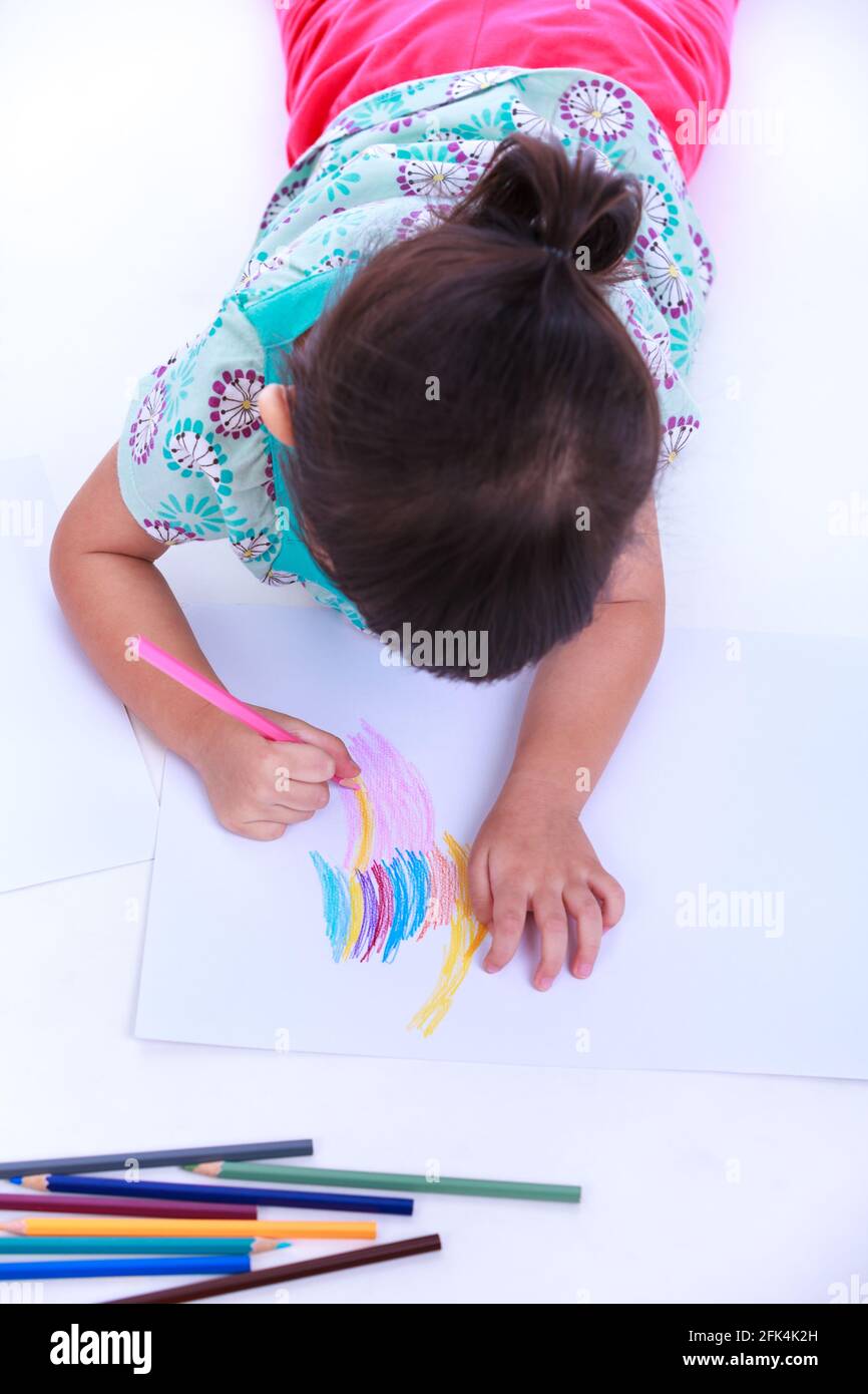 Top view. Girl lie on the floor and drawing on paper. Concepts of ...