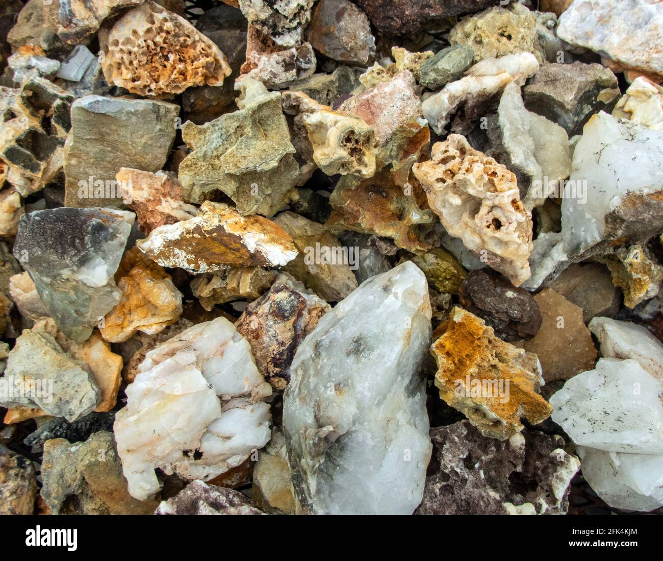 A mcaro photograph of a heap of various rocks and minerals full of ...