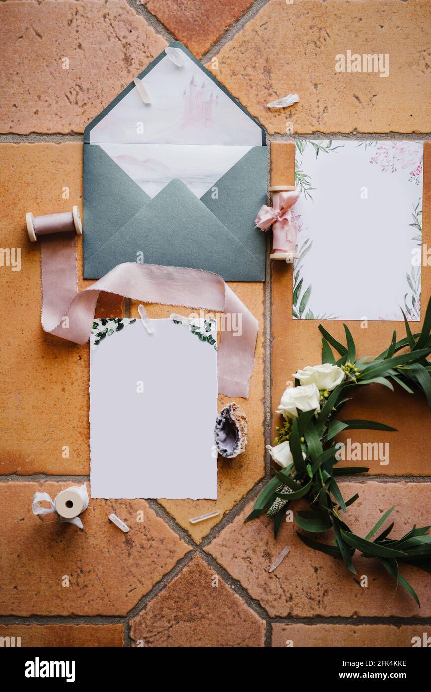 On a brown tile - an open gray envelope, blank postcards with ornaments ...