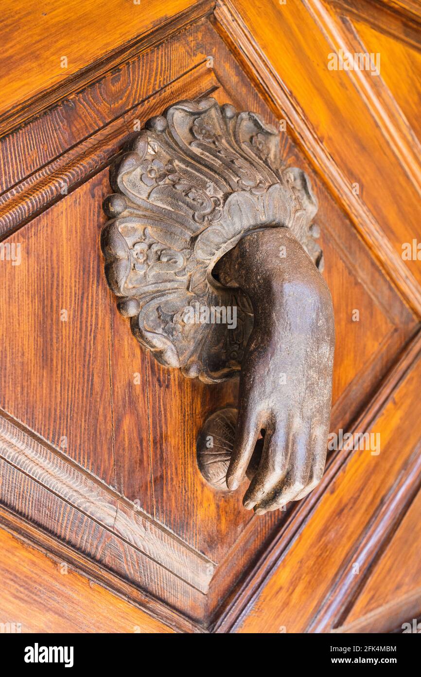 Closeup of a creative hand-shaped doorknob on a wooden door Stock Photo ...
