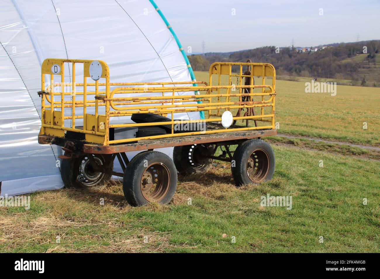 Old yellow trailer for transporting material in a meadow Stock Photo ...