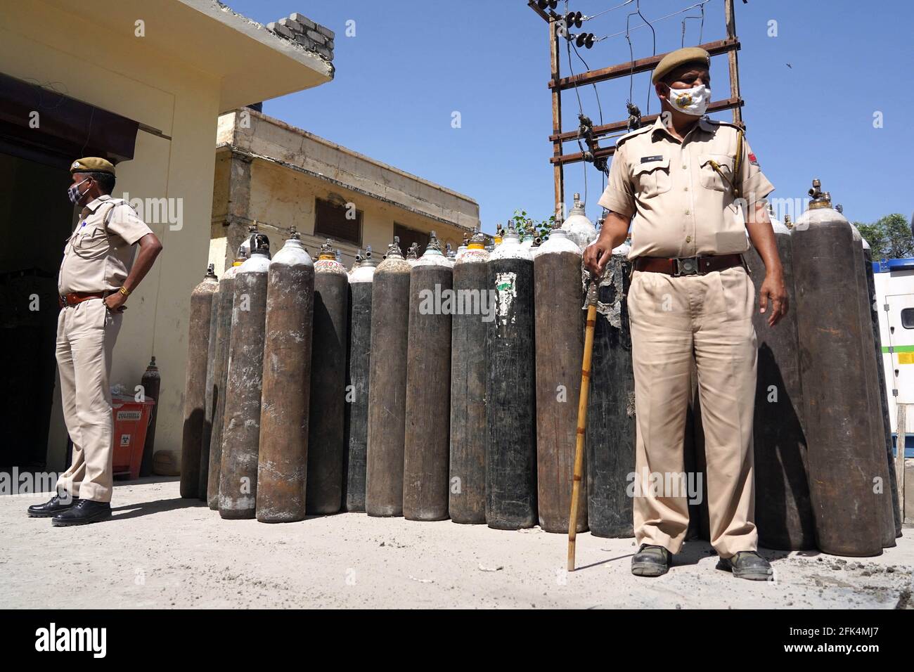 Heavy Police security during workers sort oxygen cylinders used for ...