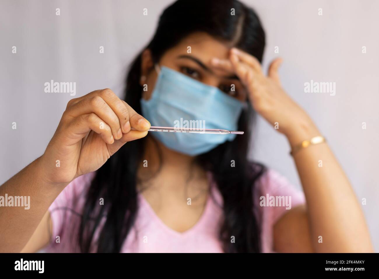Selective focus on an analog thermometer held in hand of a mid adult ...