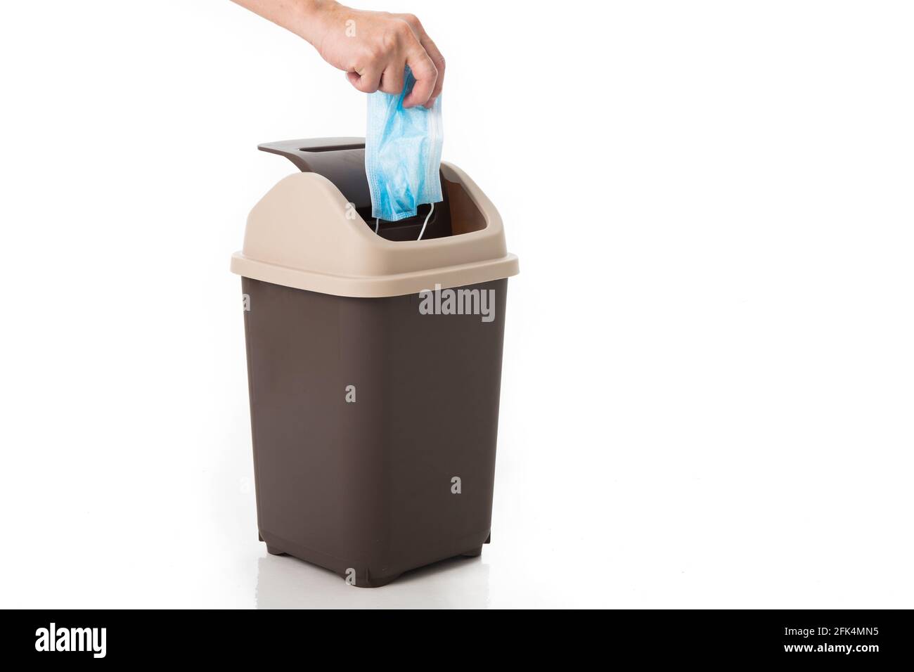 Hand Throw surgical mask in the trash. Disposable surgical mask on ...