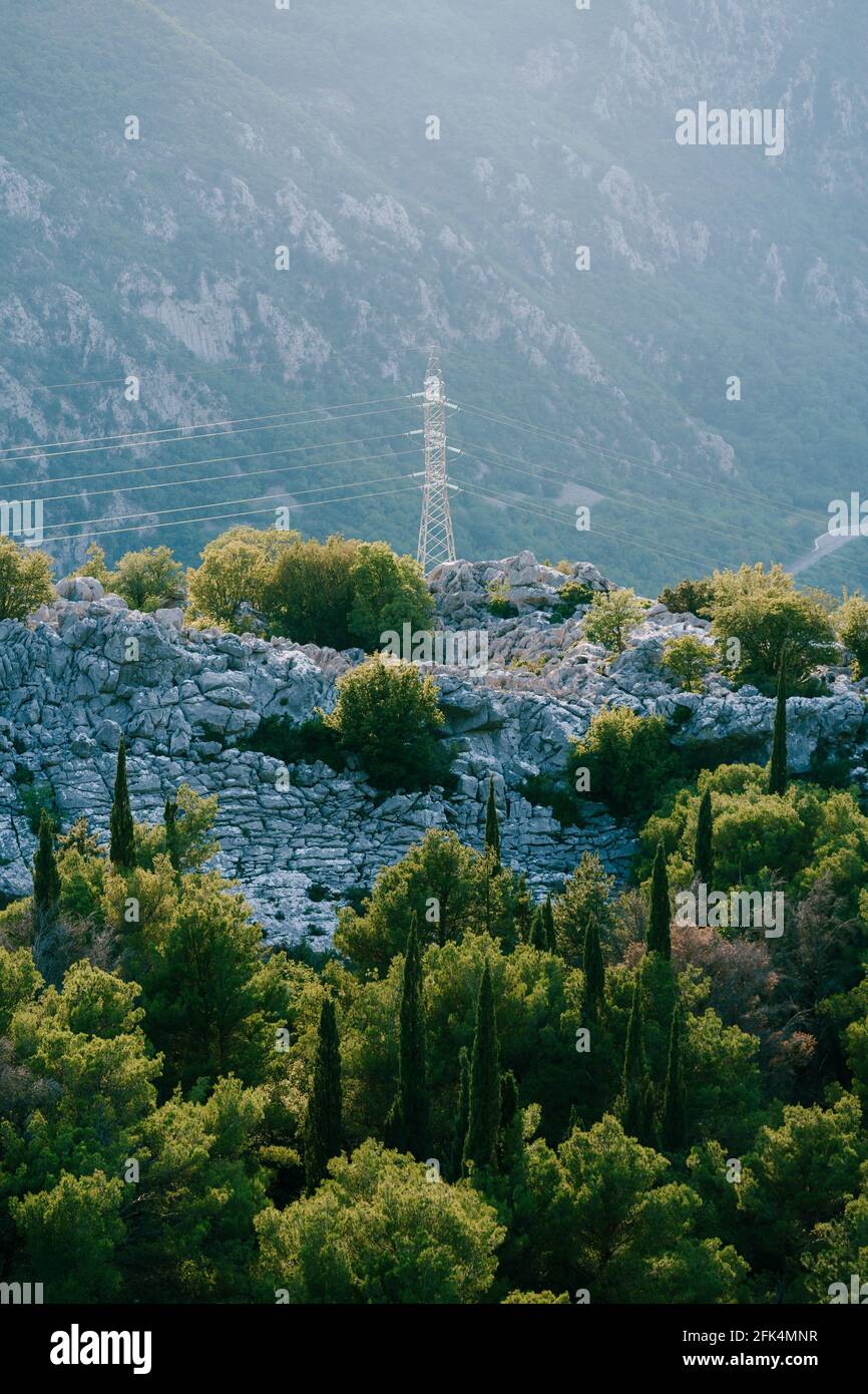 Power line pylon on the background of the stone slope of the mountain ...