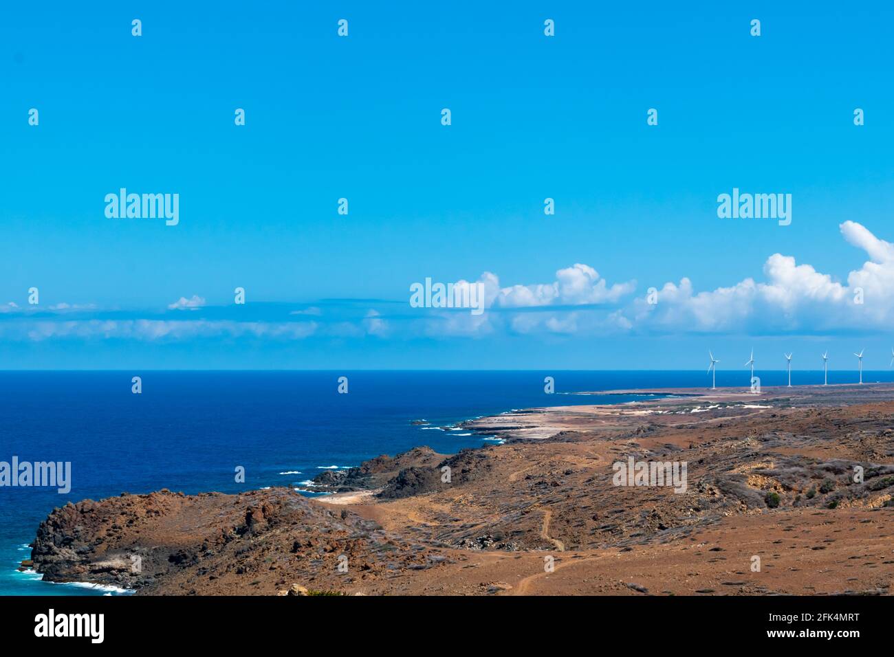 The amazing view of Aruba eastside shore. with some windmills in the ...