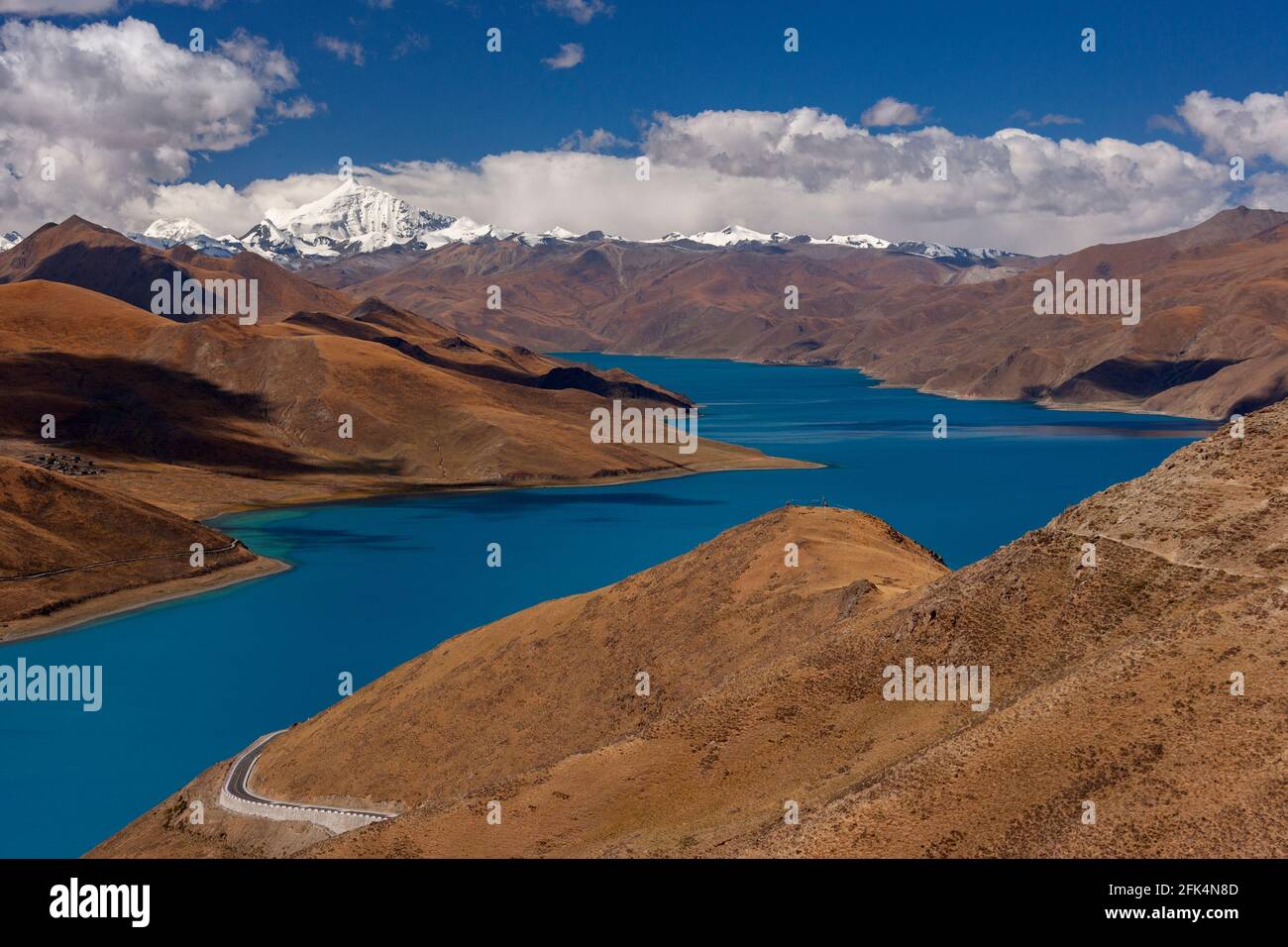 The bright blue glacial waters of Yamdrok Lake and the Gampa High Pass ...