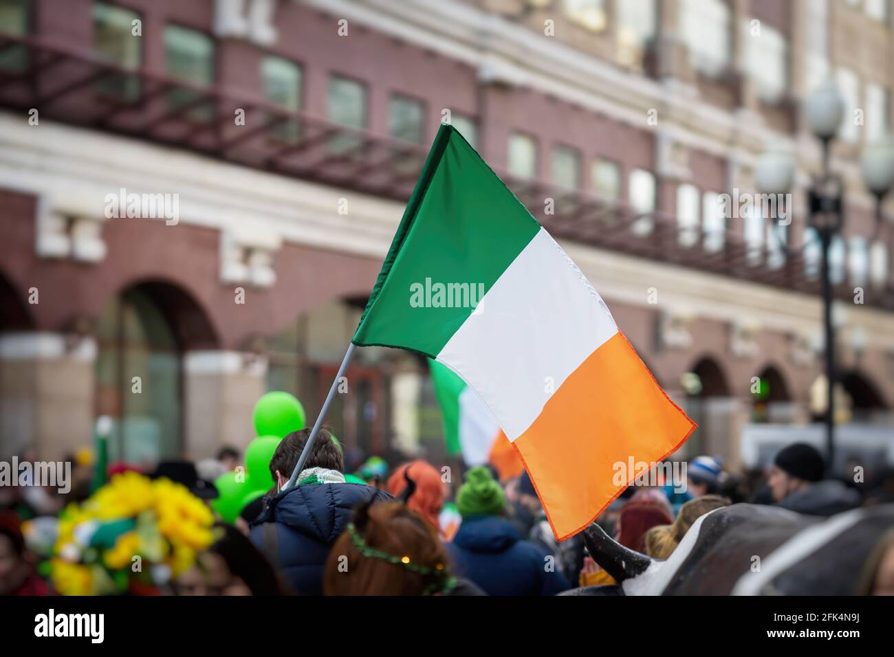 National Flag of Ireland close-up in hands of man on background of ...