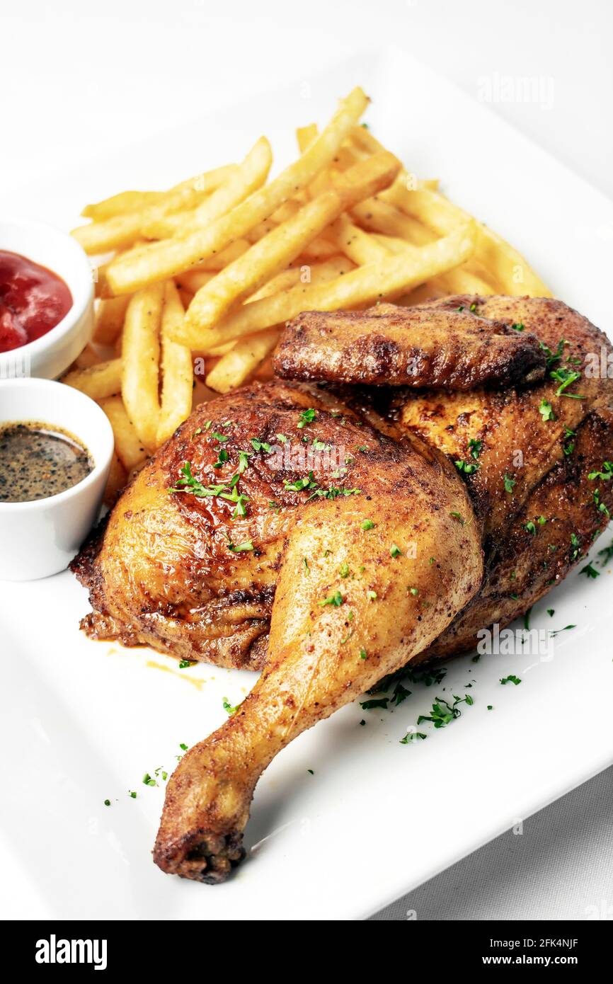 roast rotisserie half chicken with french fries simple meal on white ...