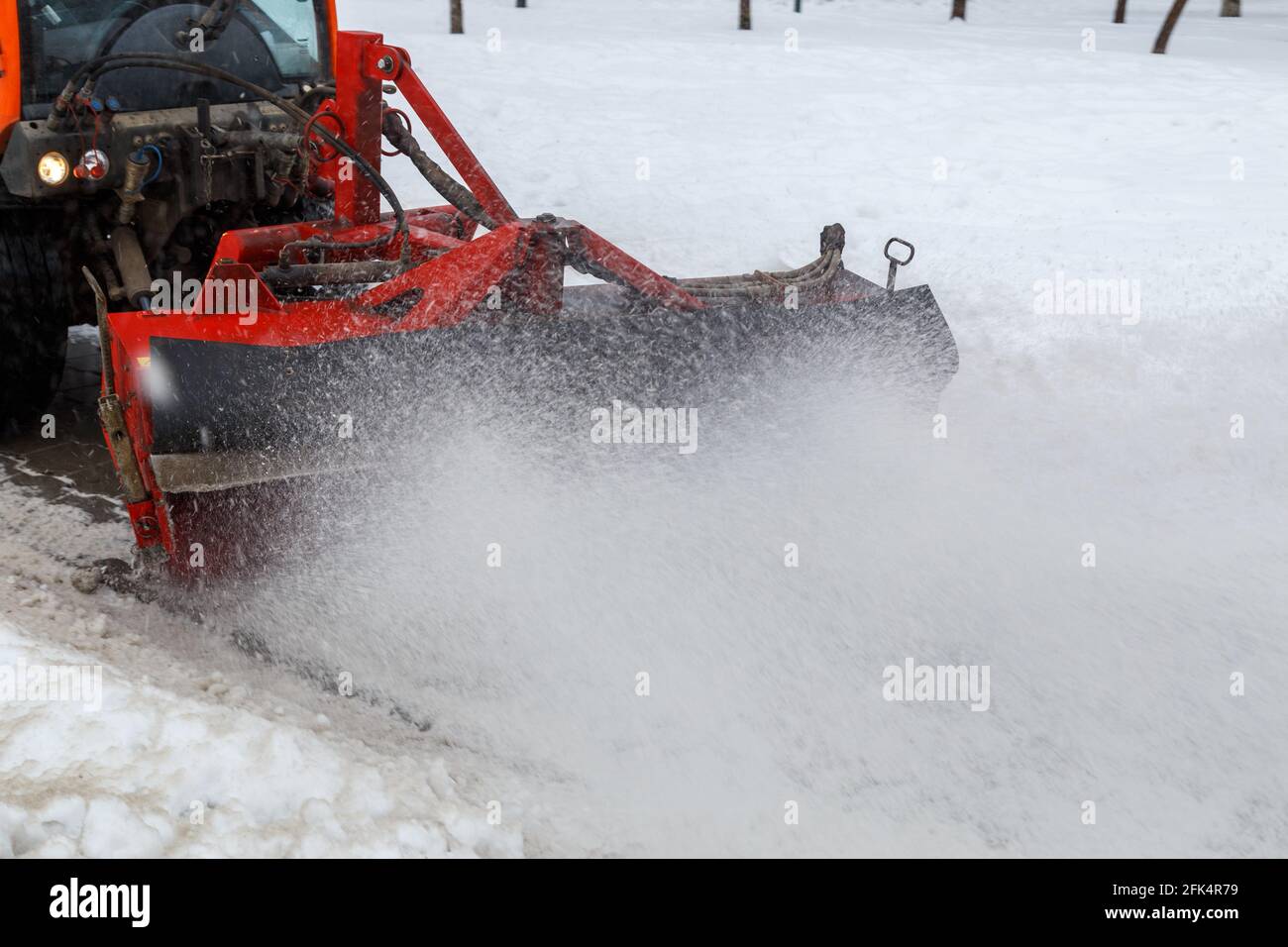 Snow cleaning process at winter city. Snow removal tractor clearing ...