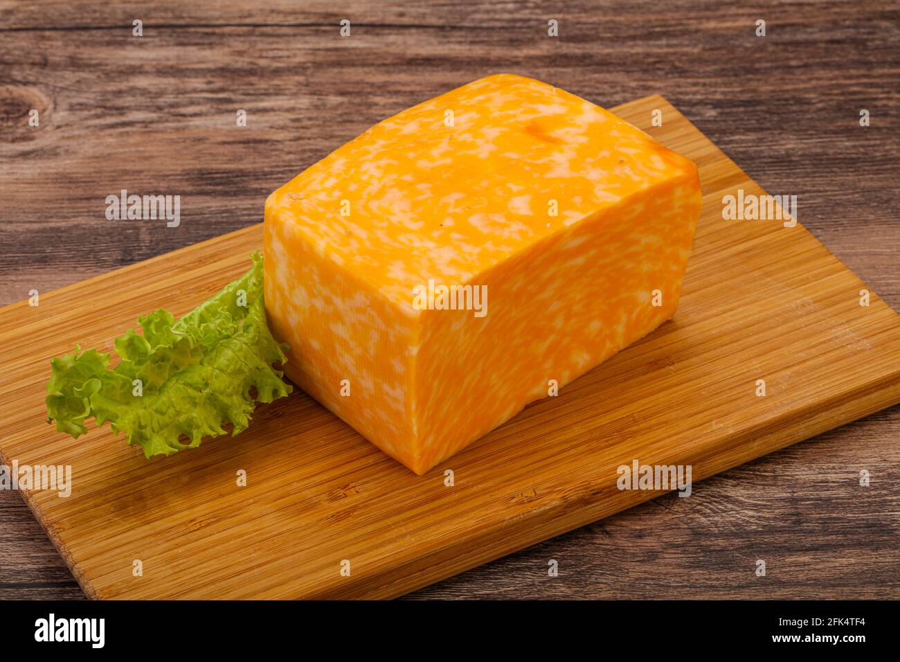 Dairy Marble cheese brick over board Stock Photo - Alamy