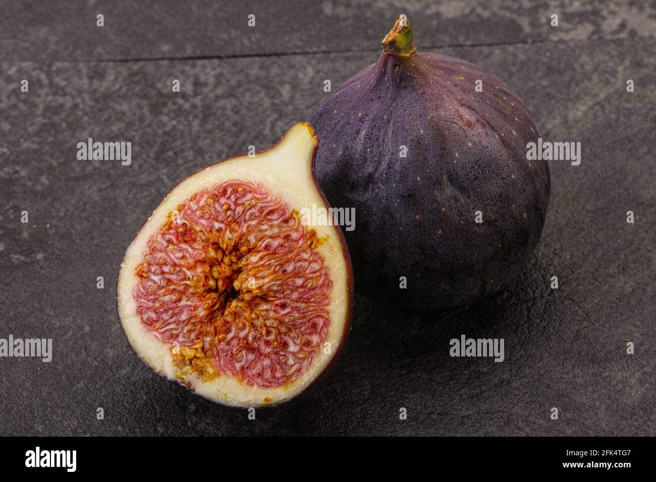 Sweet purple slice of fig fruit Stock Photo - Alamy