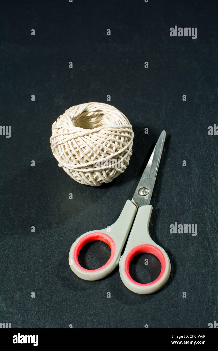 a ball of string and a scissors Stock Photo - Alamy