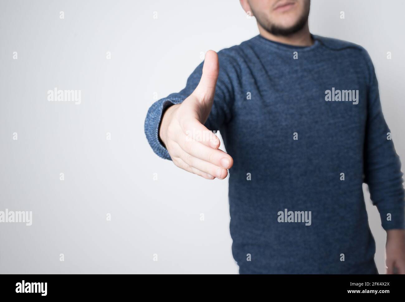 Young anonymous adult in the proccess of shaking hand, with white ...