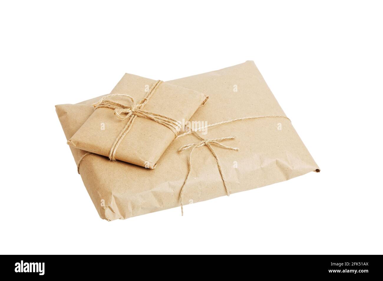 Two parcels with kraft paper tied with twine isolated on white ...