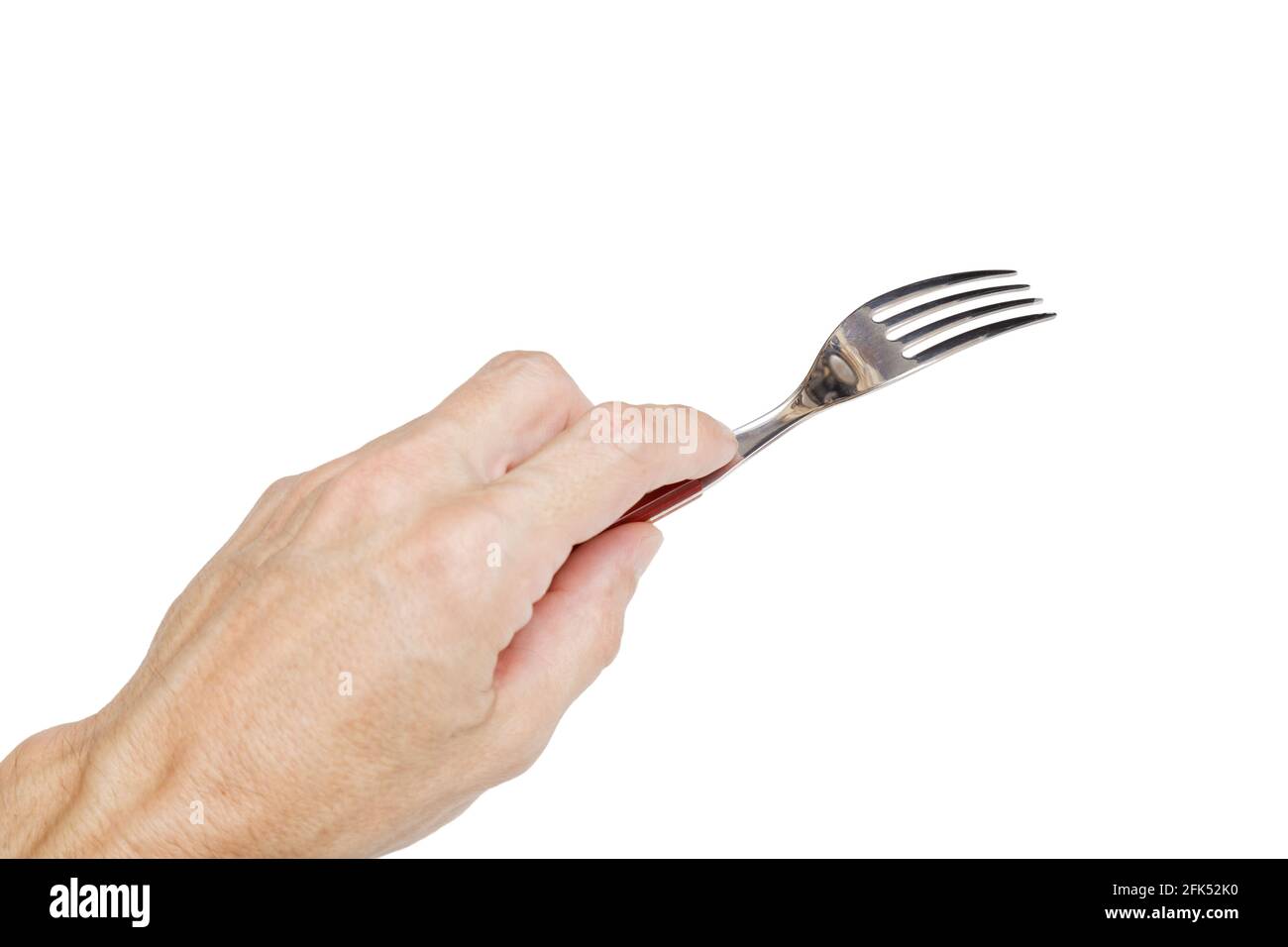 Humans left hand holding a silver fork isolated on white. Concept Stock ...