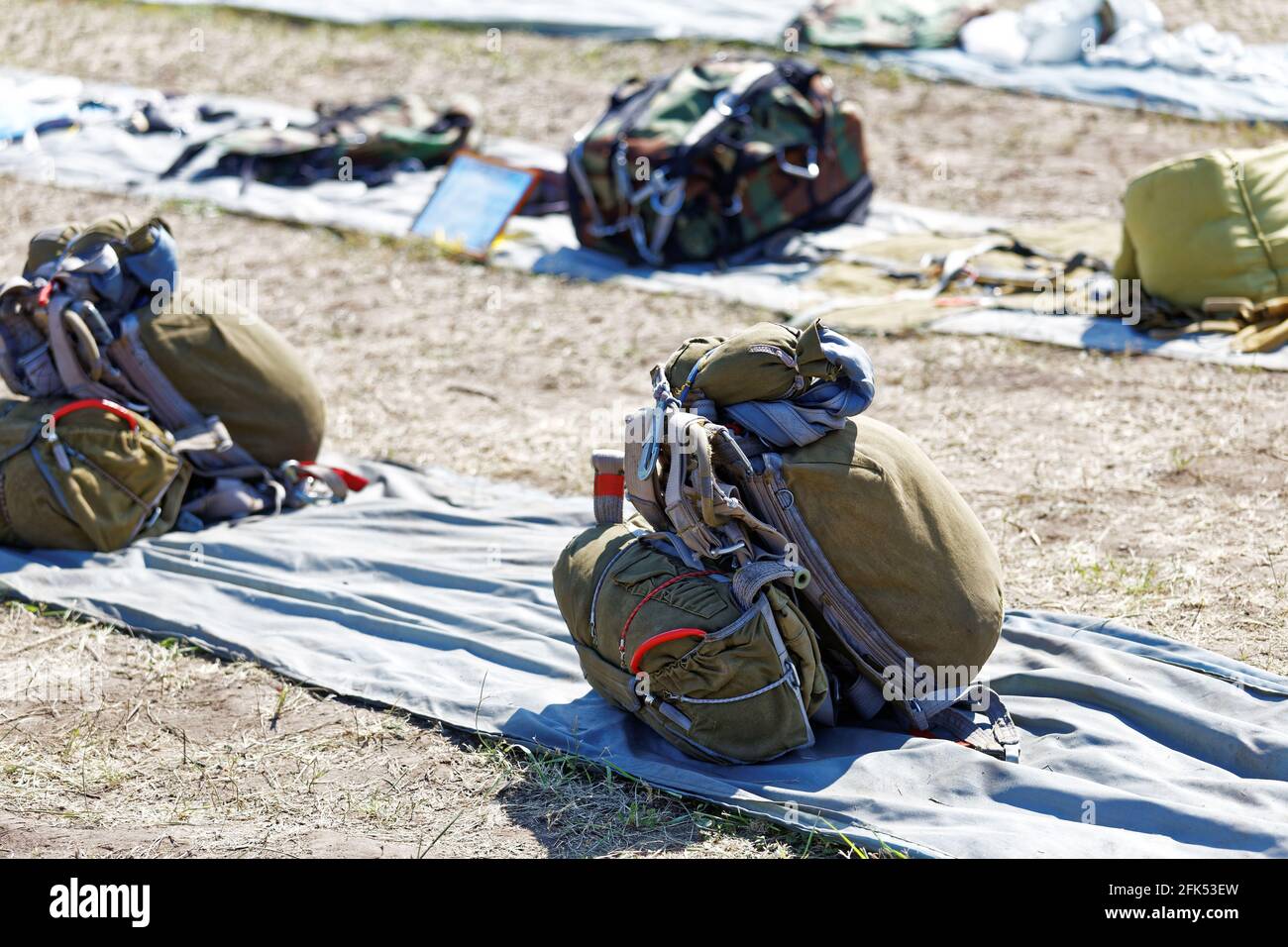 Packed parachutes spread out on the ground Stock Photo - Alamy