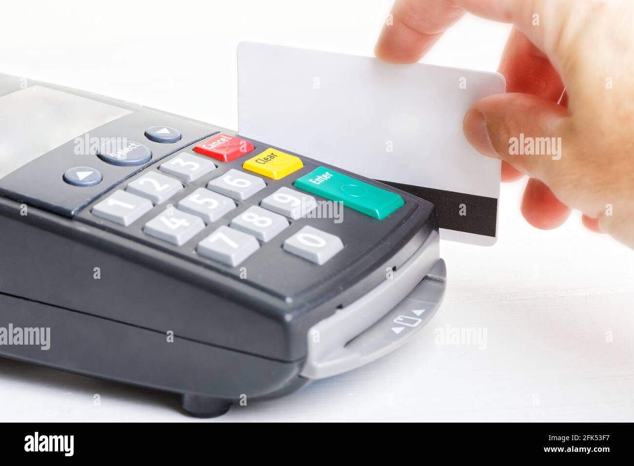 Closeup payment terminal and human hand holding plastic card in moment ...