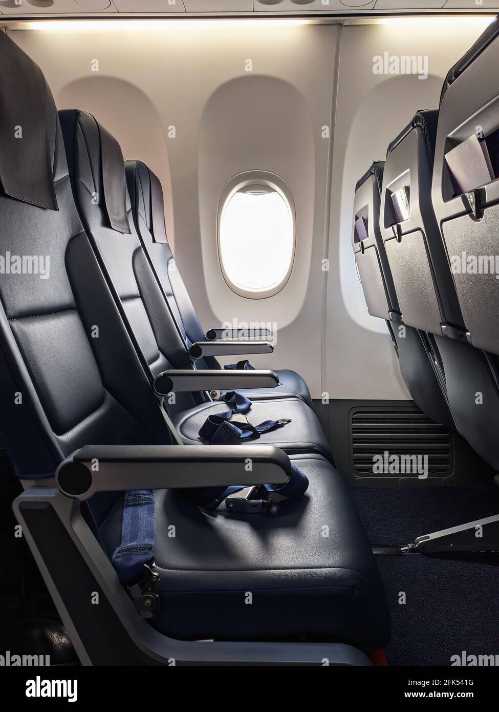 Empty aircraft seats and window. Side view Stock Photo - Alamy