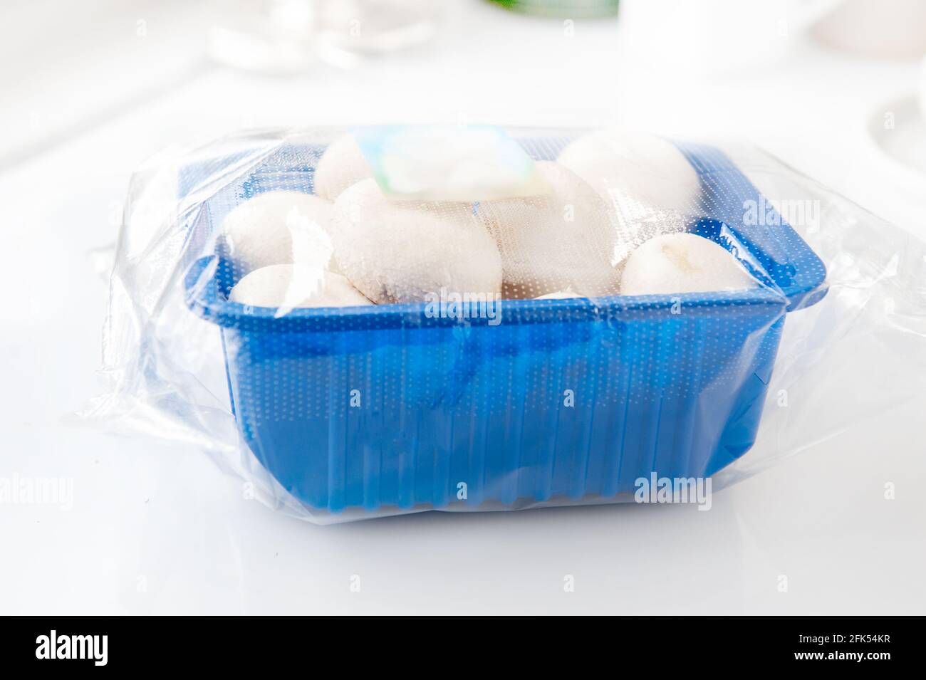 packaged mushrooms are sold at a local vegetable seller in the market ...