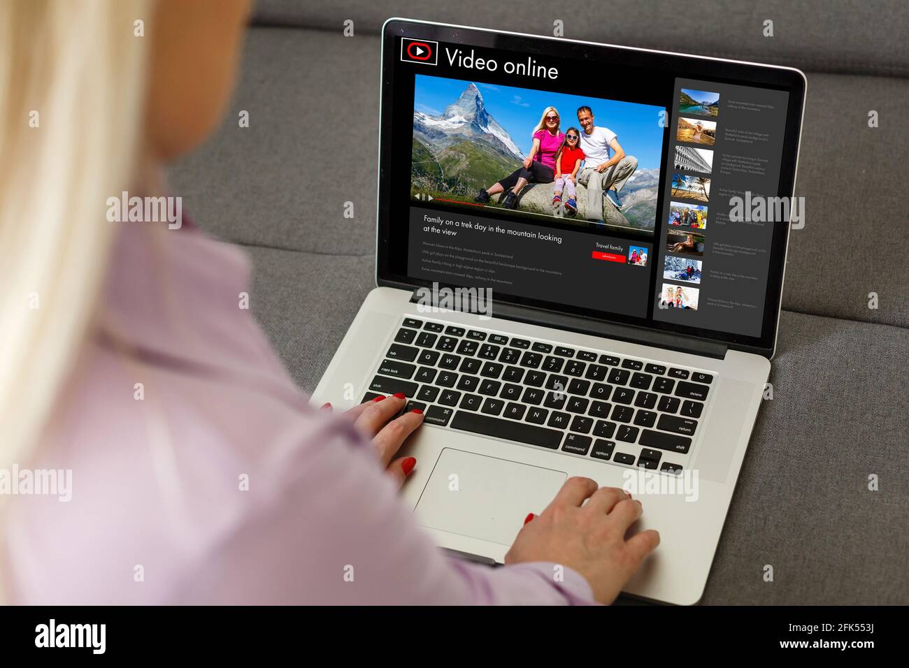 Woman watching videos online on laptop Stock Photo - Alamy