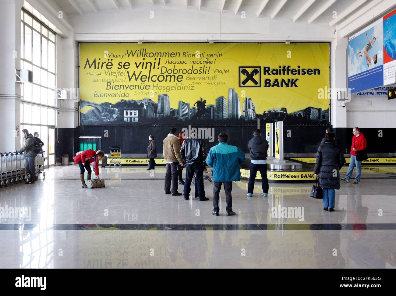 People waiting at the luggage belt at Pristina airport, Kosovo Stock ...