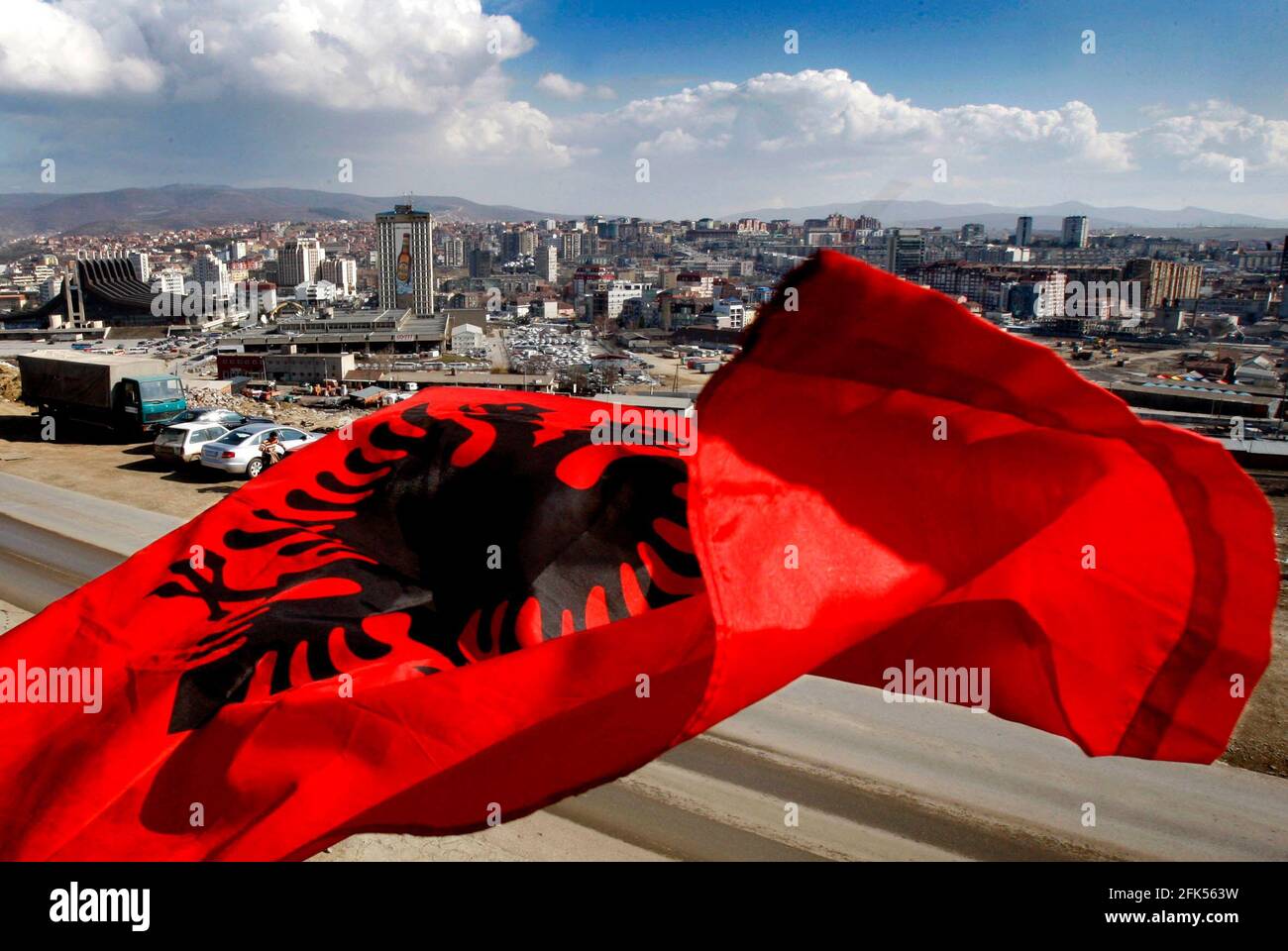 Countryroad outside the capital Pristina in Kosovo. Kosovo flag in the ...