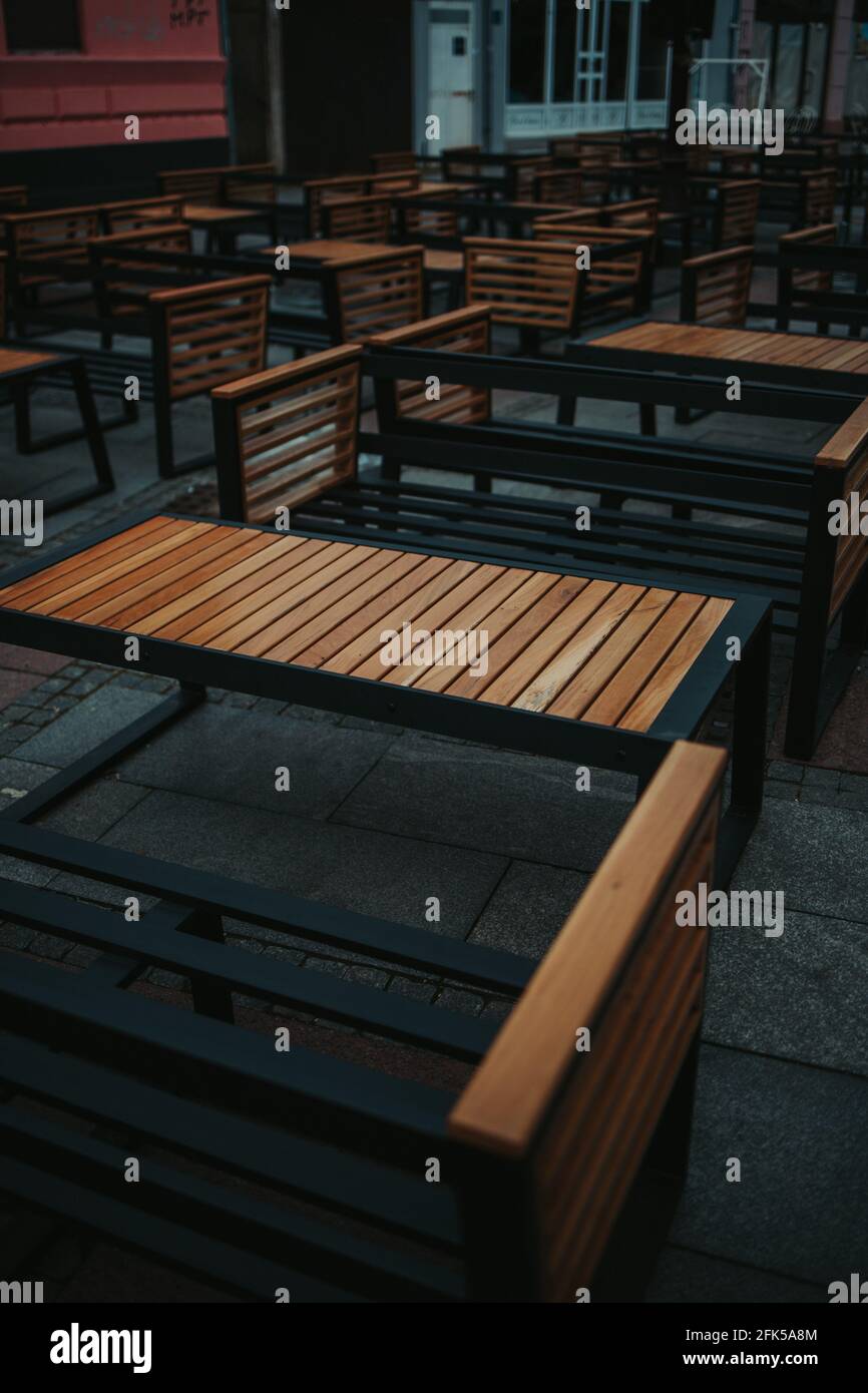 Vertical shot of empty cafe tables and benches outdoors Stock Photo - Alamy