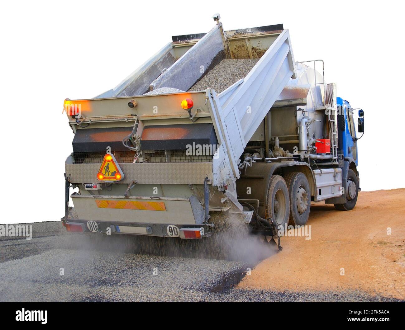 Construction of a road by trucks with aggregates and tar Stock Photo ...