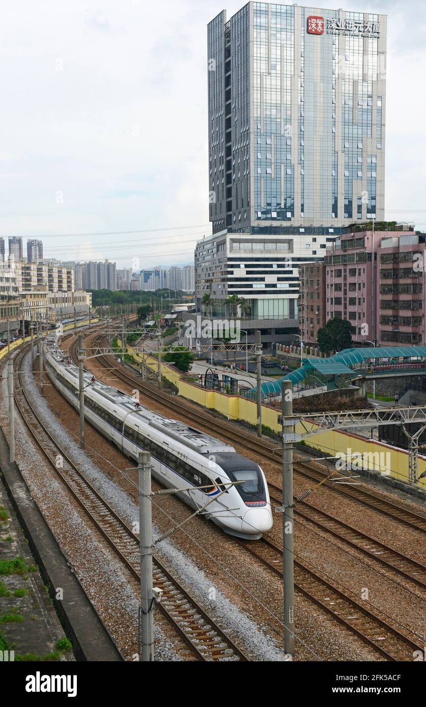 A high speed train passes through the central area of Shenzhen, China ...