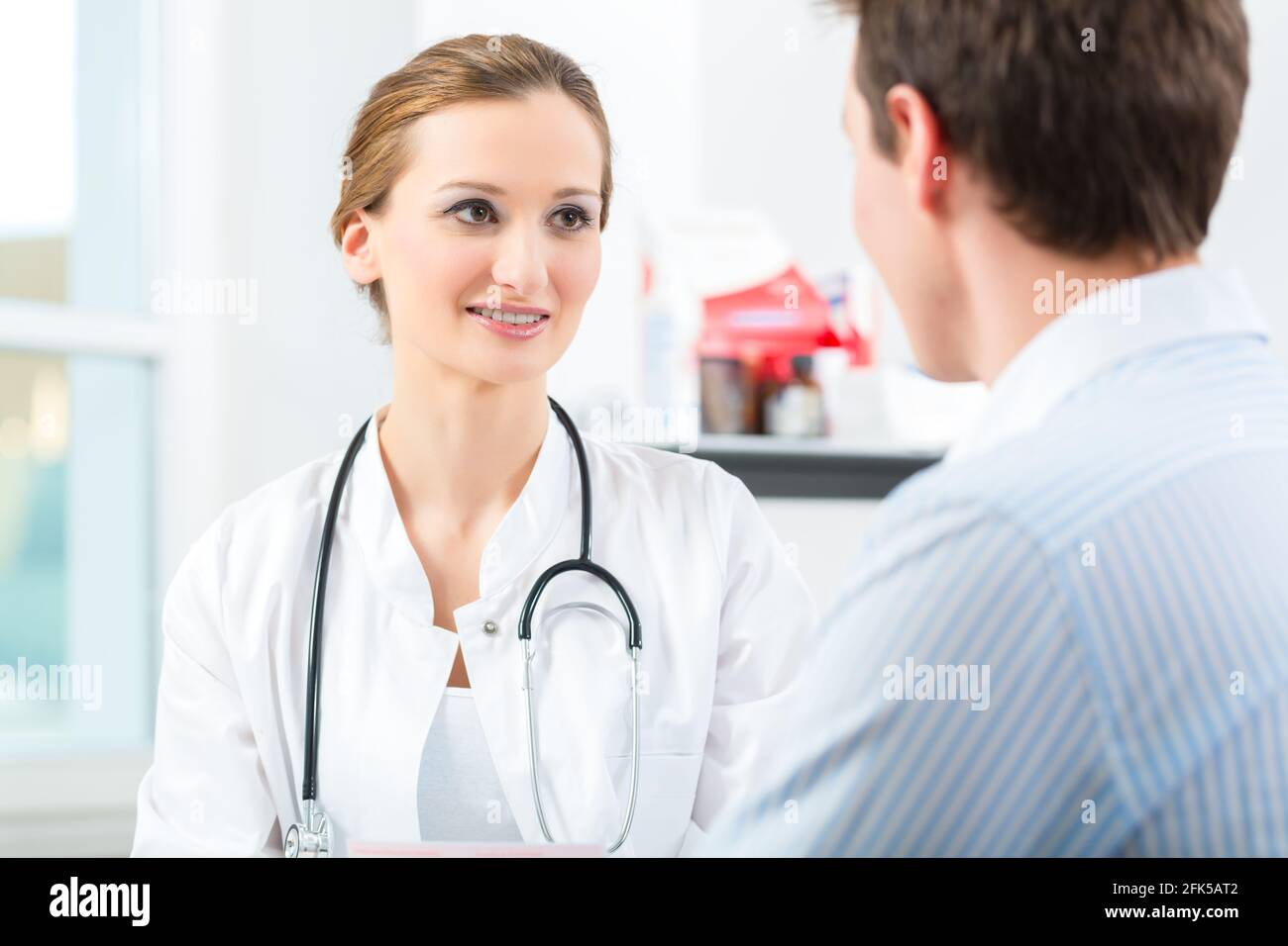 Female doctor with her patient in a consultation in clinic explaining ...