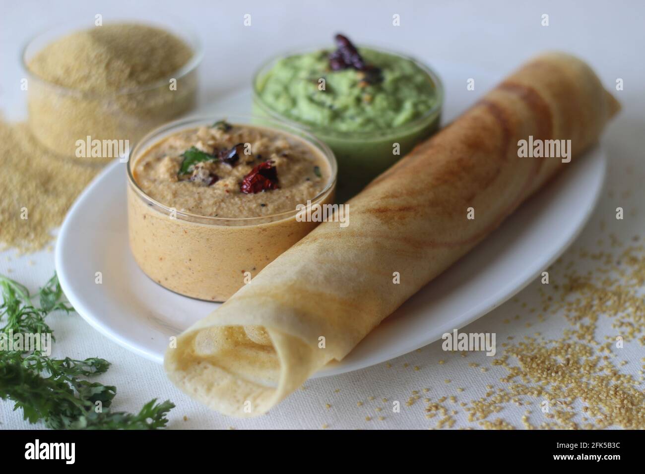 Crispy pancake made of fermented foxtail millet batter. Served with a ...