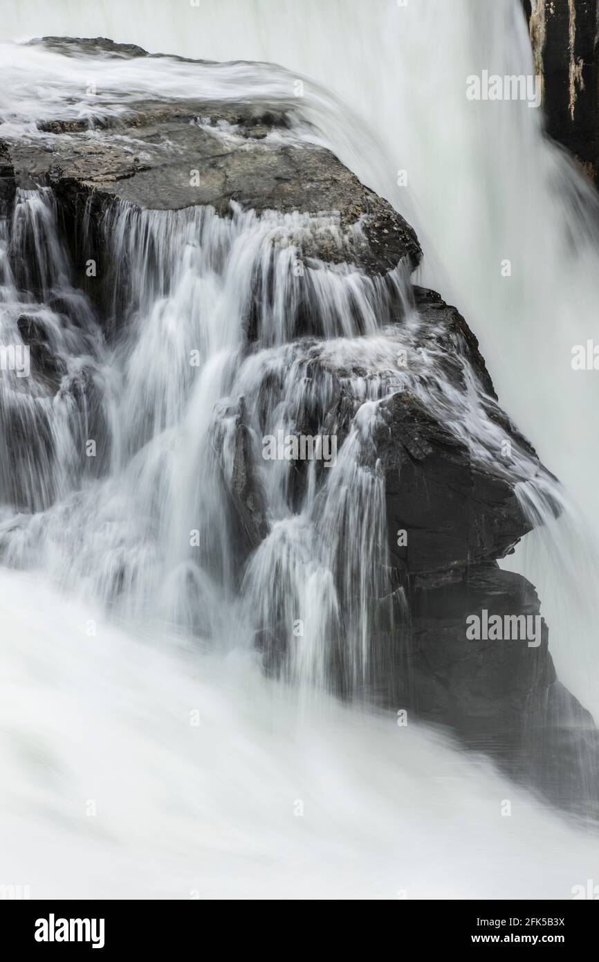 Water from the Spokane River flows rapidly over large rocks at the Post Falls Dam in Post Falls ...