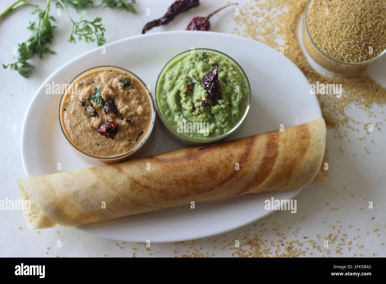 Crispy pancake made of fermented foxtail millet batter. Served with a ...