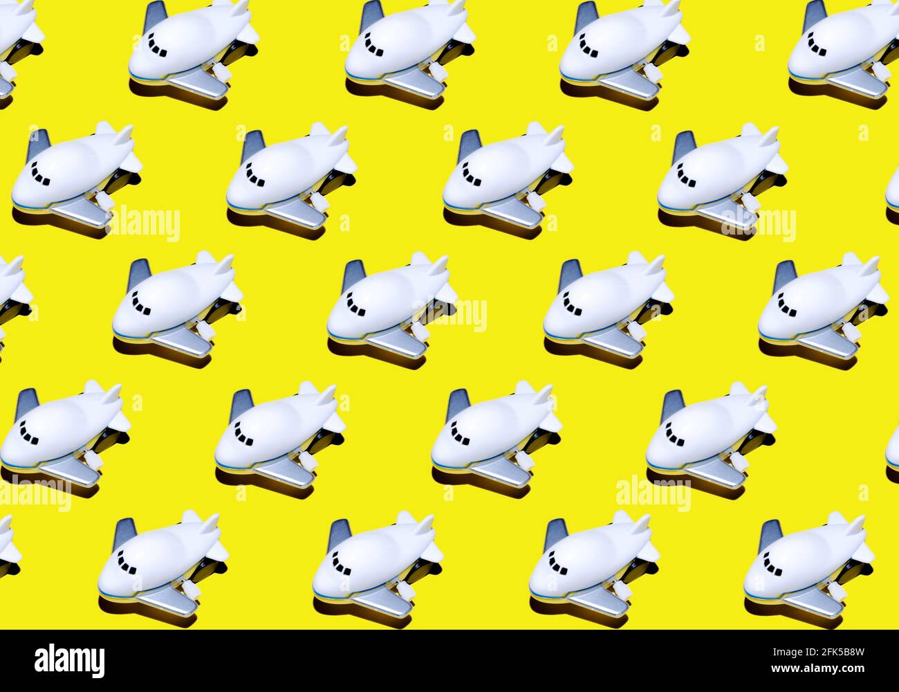 Toy airplanes pattern on yellow background. Travel on summer vacation ...