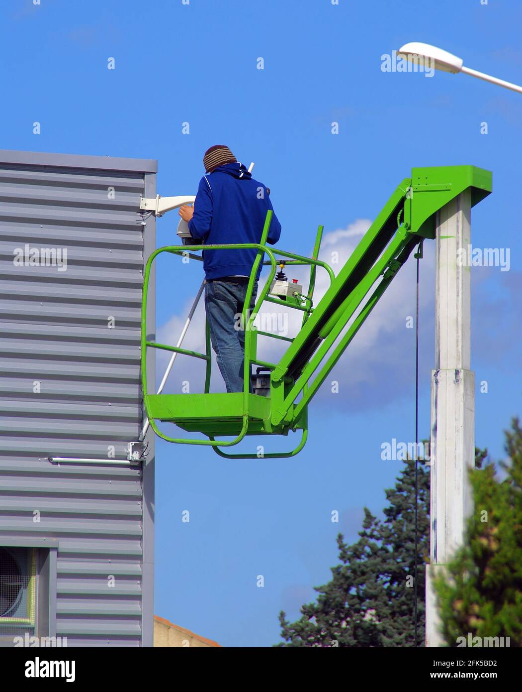 Maintenance of lampposts on an industrial building Stock Photo - Alamy
