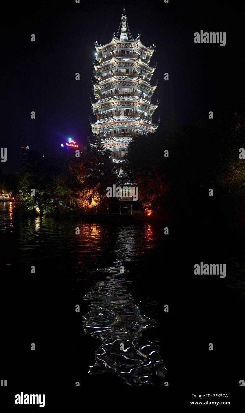 The Moon pagoda in Guilin lit up at night. Sun and Moon pagodas were ...