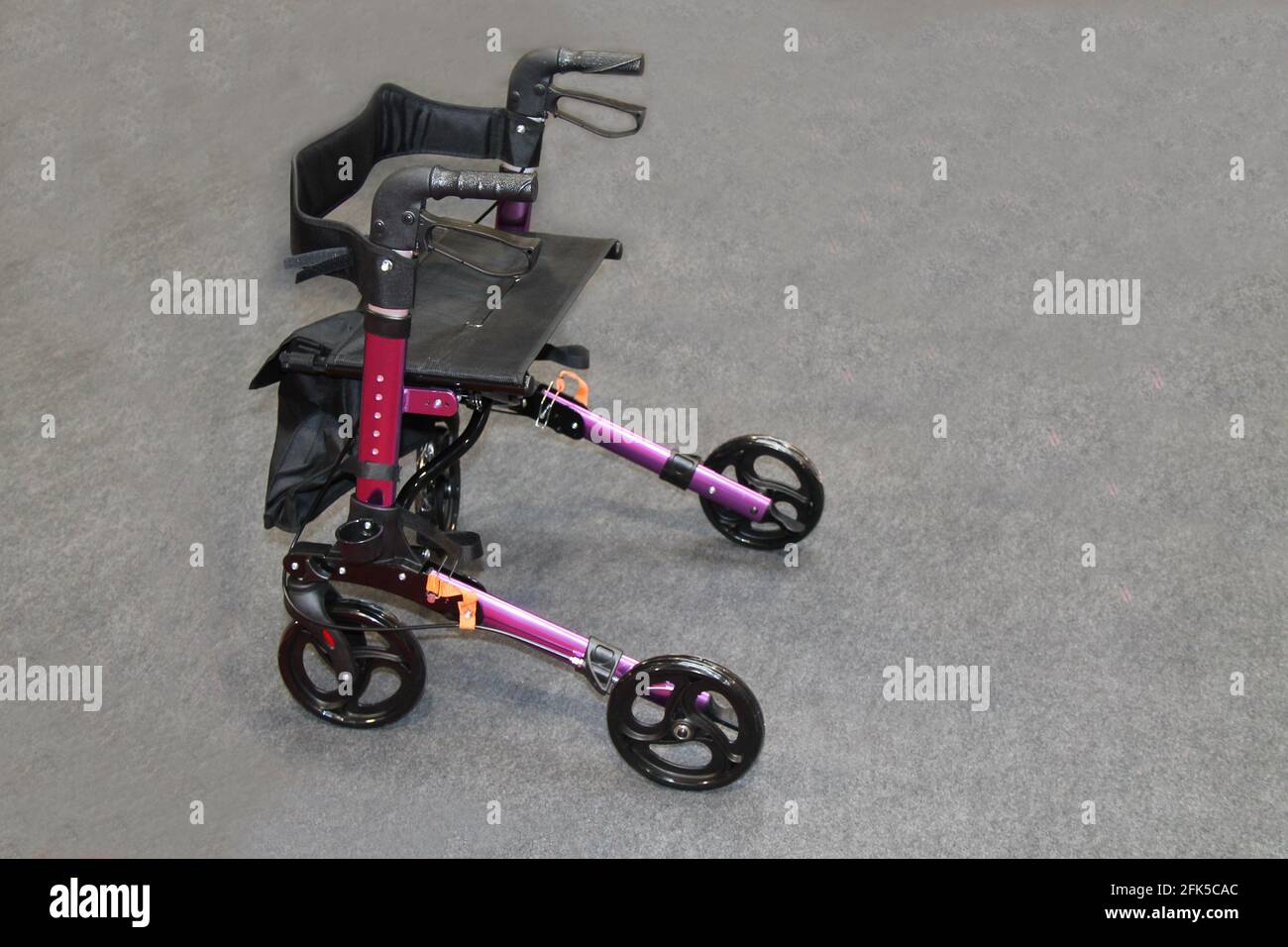 A Combined Walking Frame with a Seat on Wheels Stock Photo - Alamy